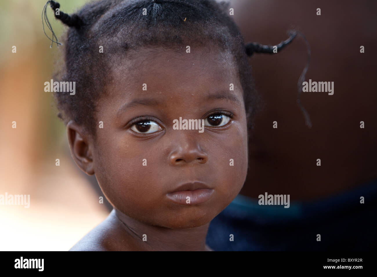 A close-up face shot of a young African girl whose family is benefiting ...