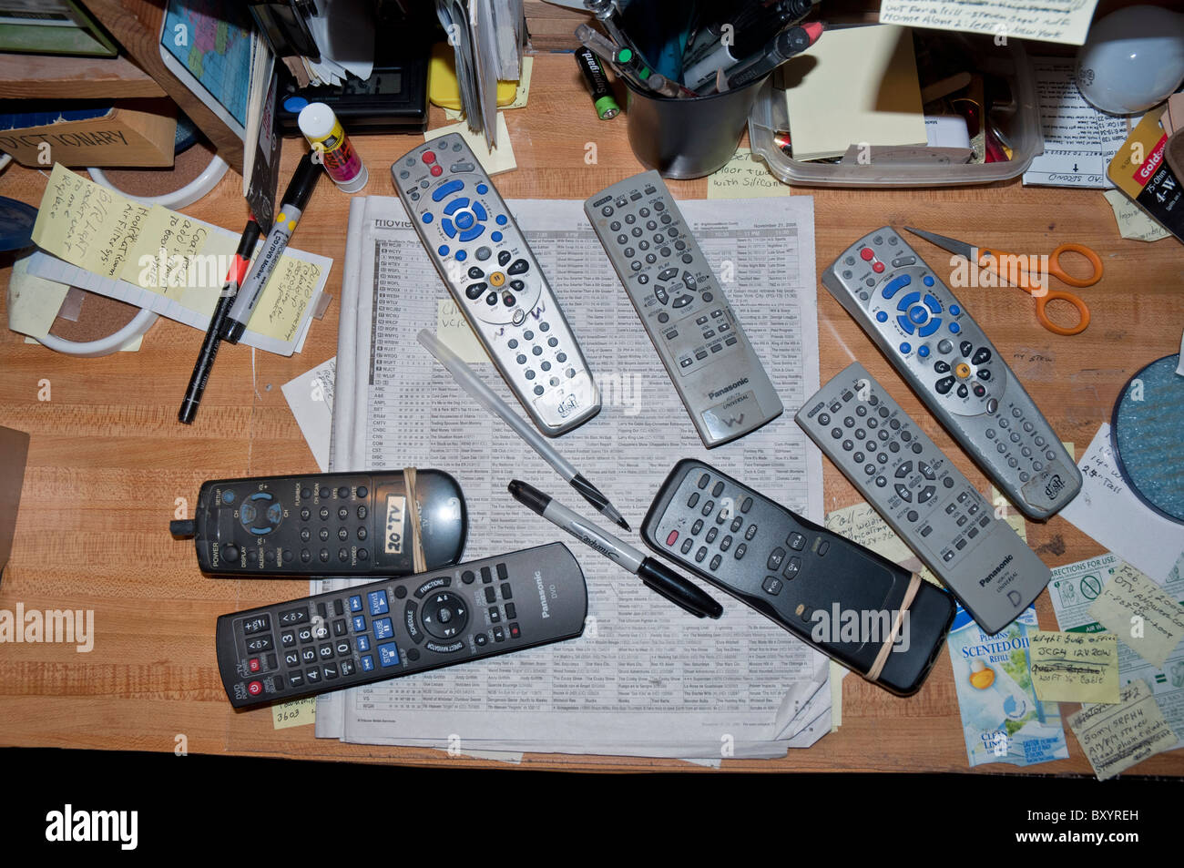 bunch of remote controls sitting on desk Stock Photo - Alamy