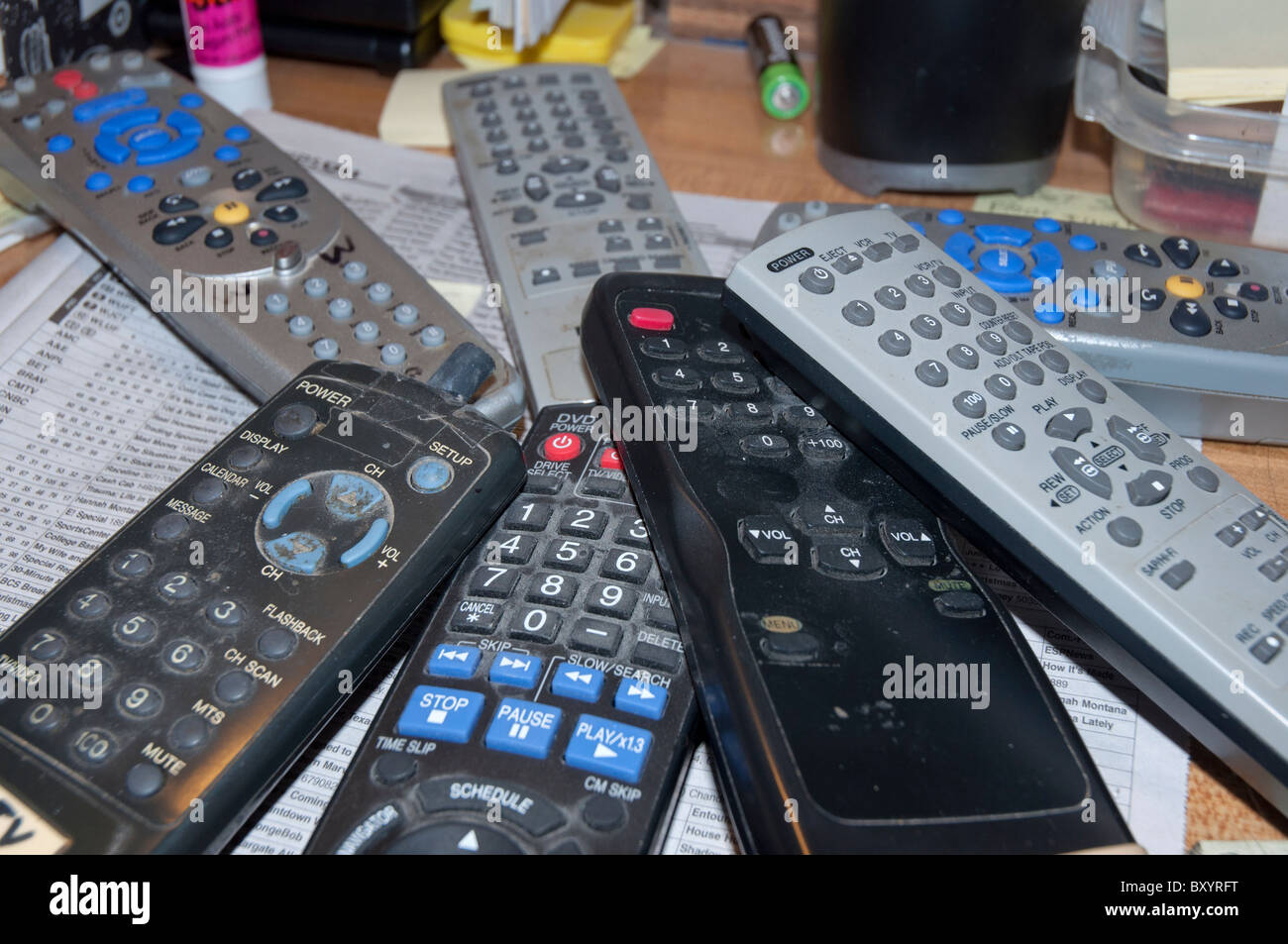 bunch of remote controls sitting on desk Stock Photo - Alamy