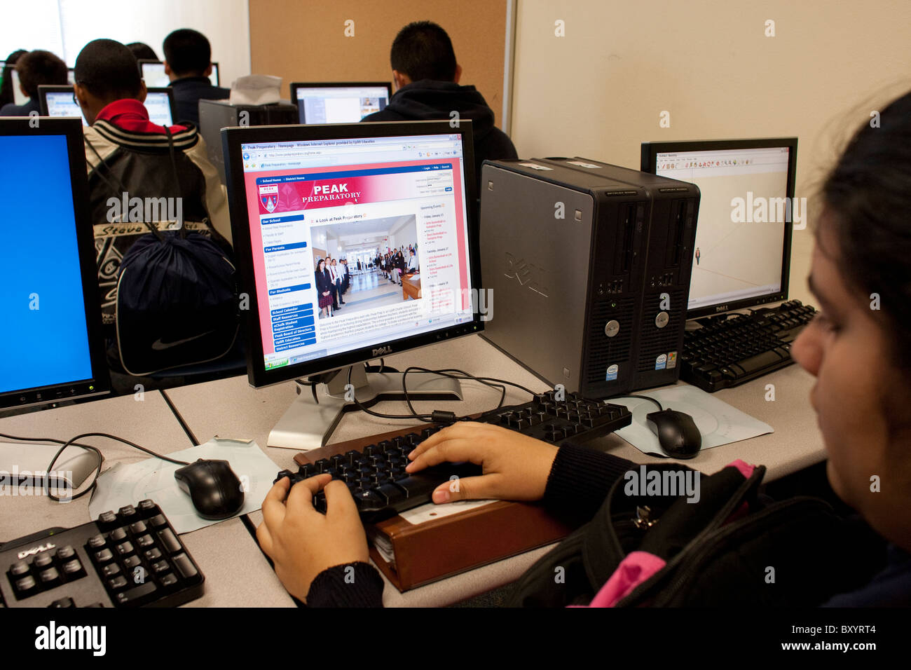 Male and female Hispanic and African American students work on ...