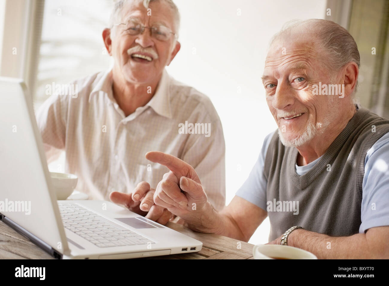 Senior men using laptop Stock Photo - Alamy