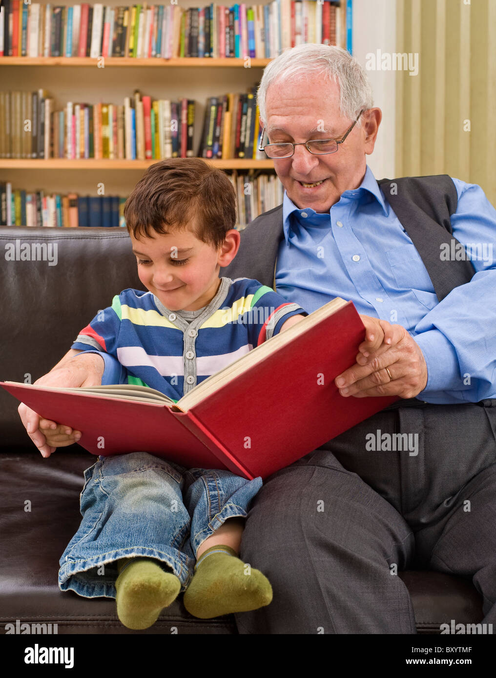 grandfather reading a story to his grandchild Stock Photo - Alamy