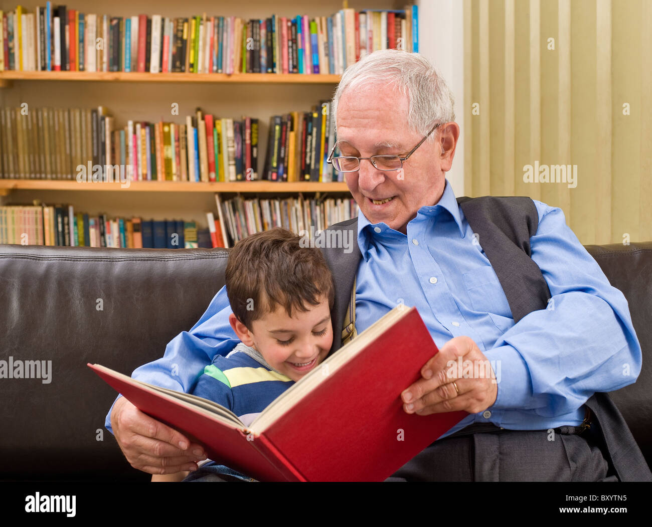 grandfather reading a story to his grandchild Stock Photo - Alamy