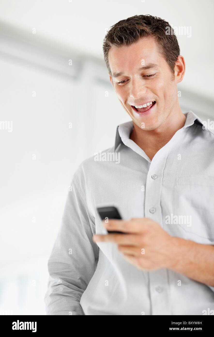 Portrait of good-looking mid adult man text messaging Stock Photo - Alamy