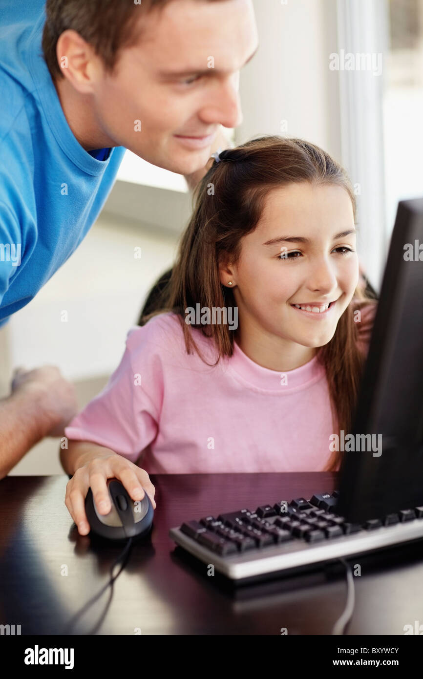 Father with daughter playing with computer Stock Photo - Alamy
