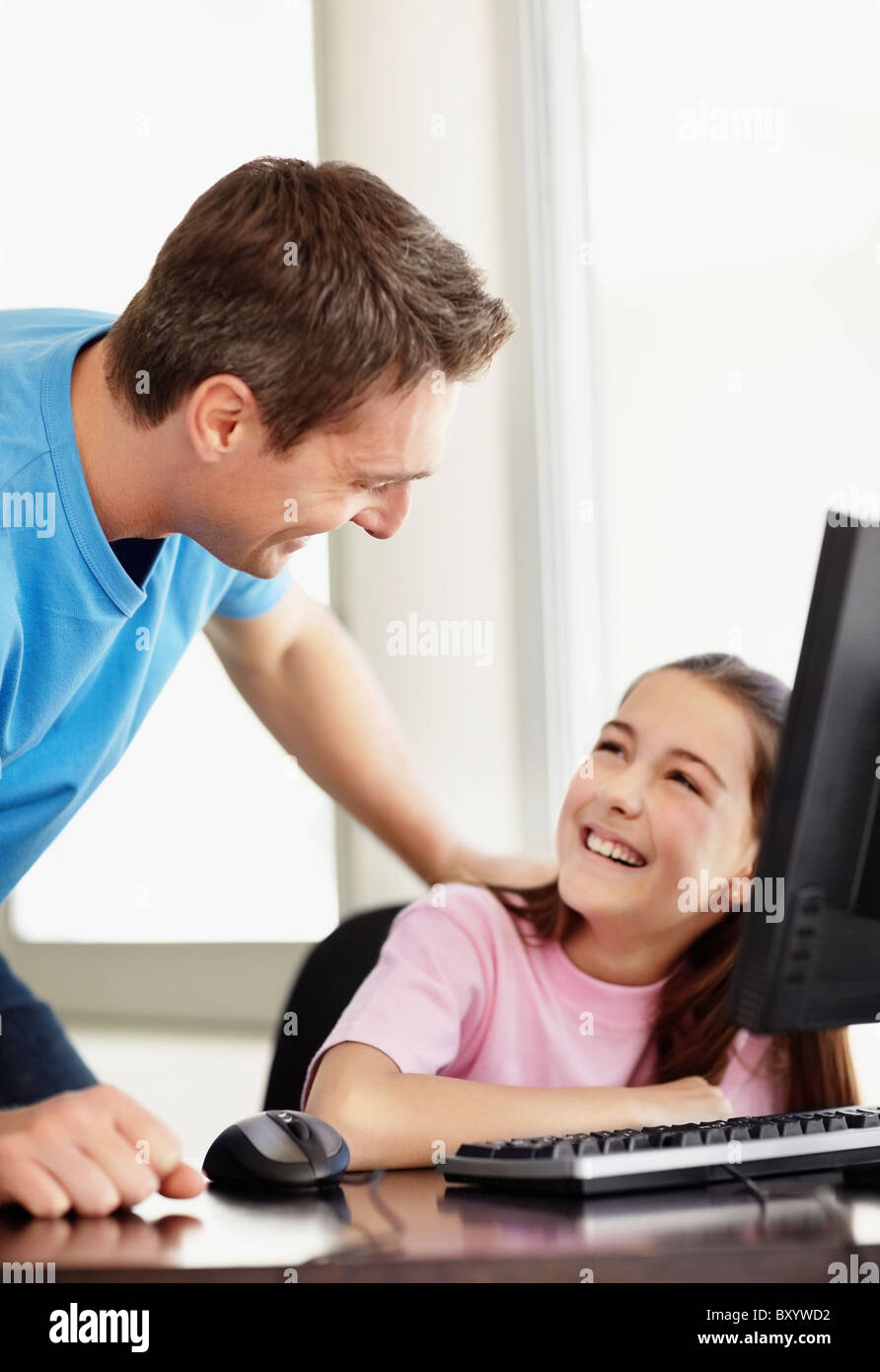 Father with daughter playing with computer Stock Photo - Alamy
