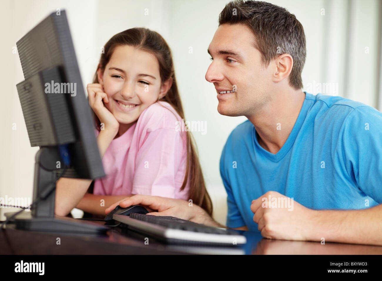 Father with daughter playing with computer Stock Photo - Alamy