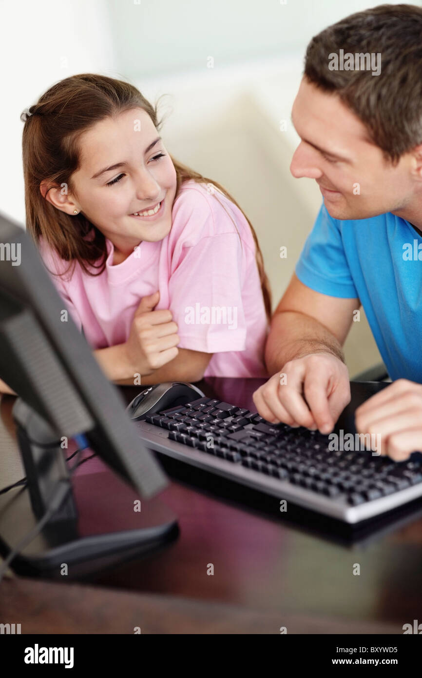Father with daughter playing with computer Stock Photo - Alamy