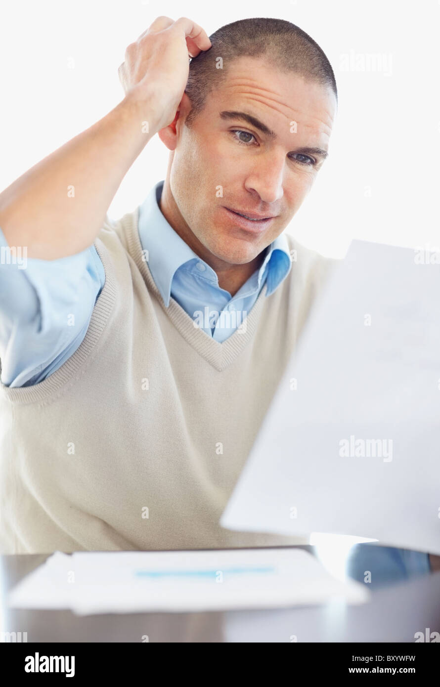 Office worker scratching behind ear Stock Photo - Alamy