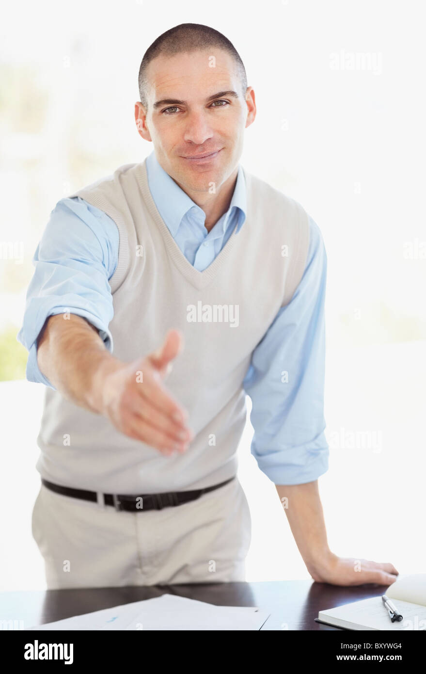 Mid adult man offering hand for handshake Stock Photo - Alamy