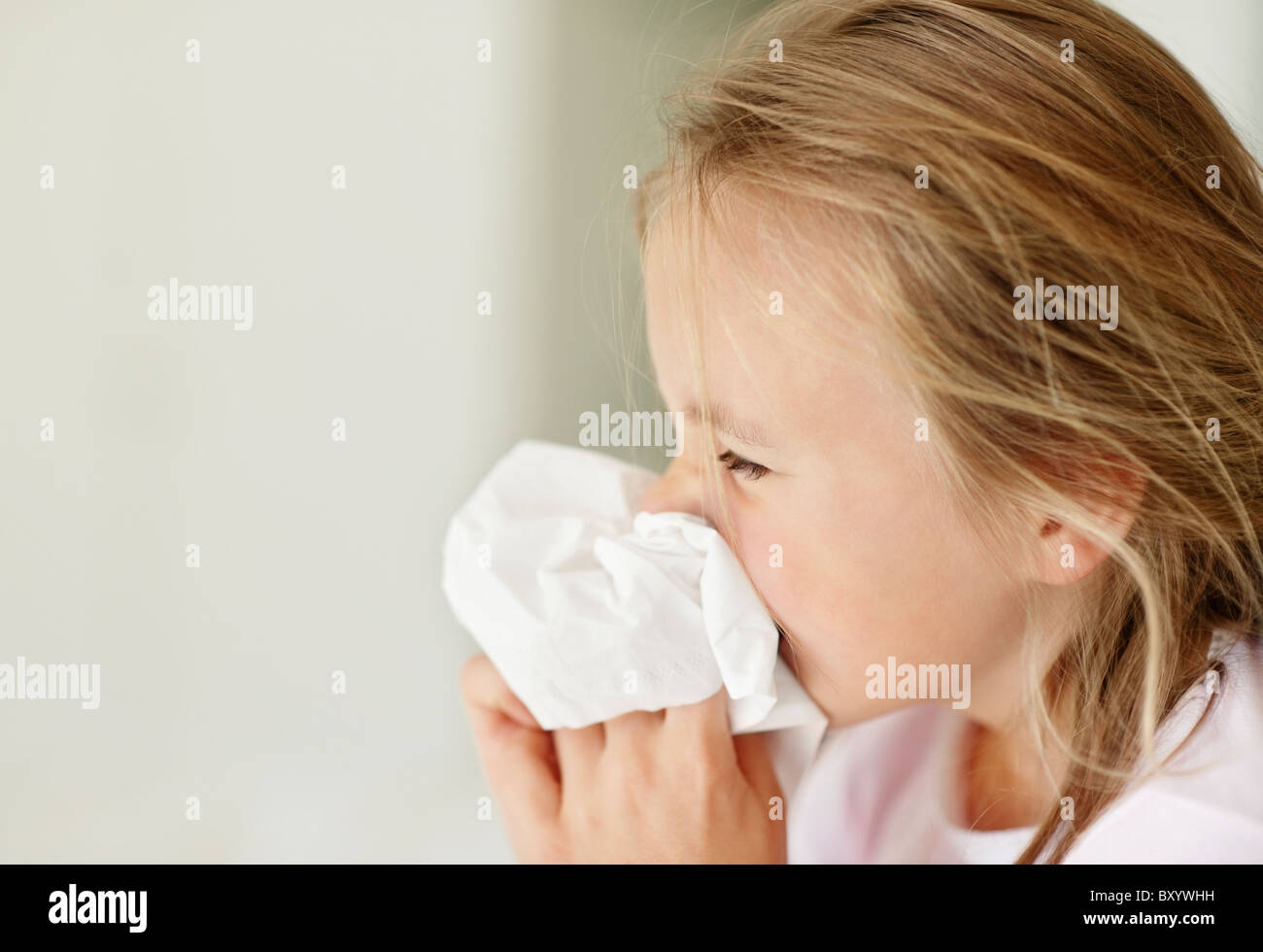Girl blowing nose Stock Photo - Alamy