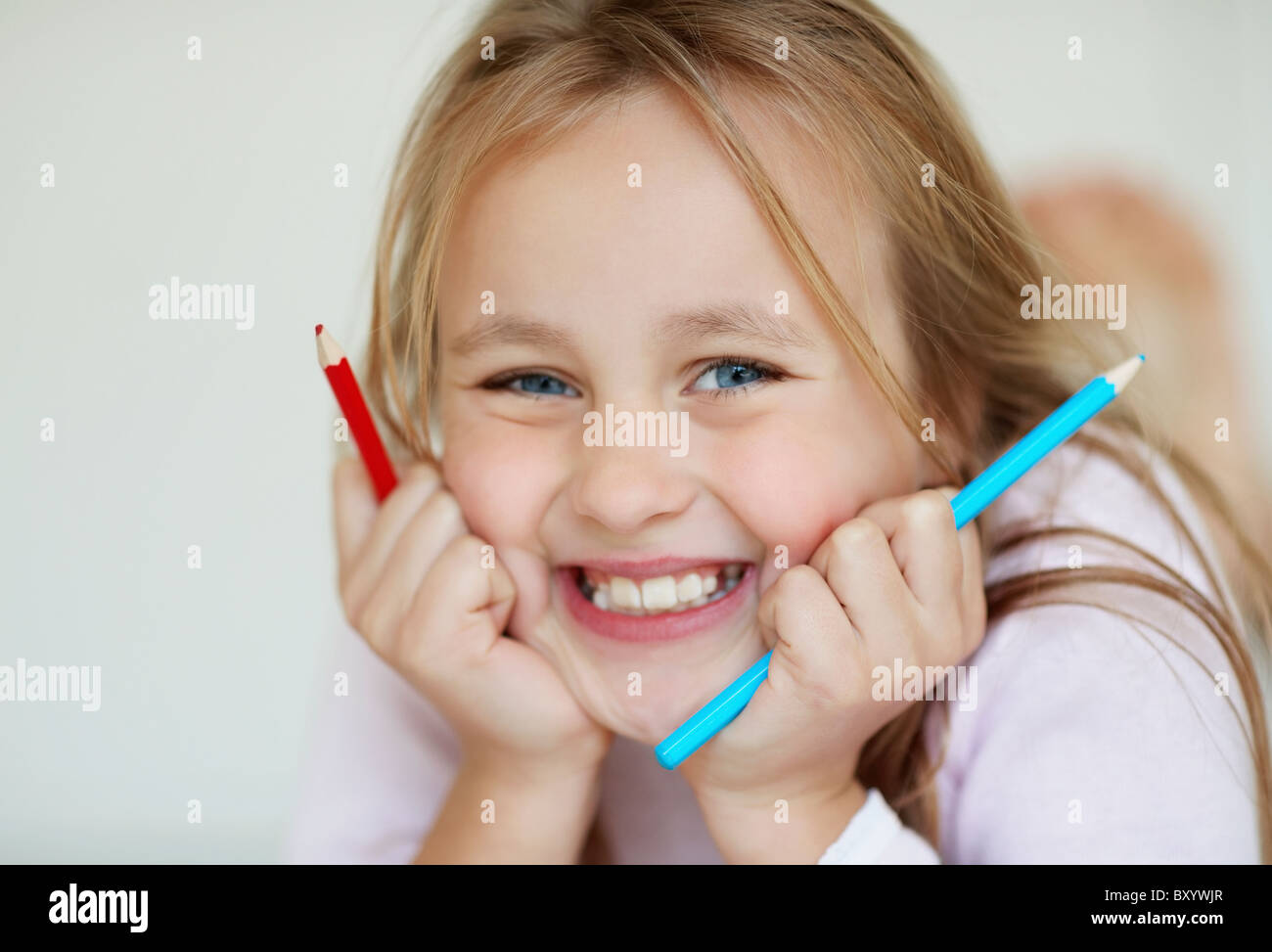 Girl holding red and blue pencils Stock Photo - Alamy