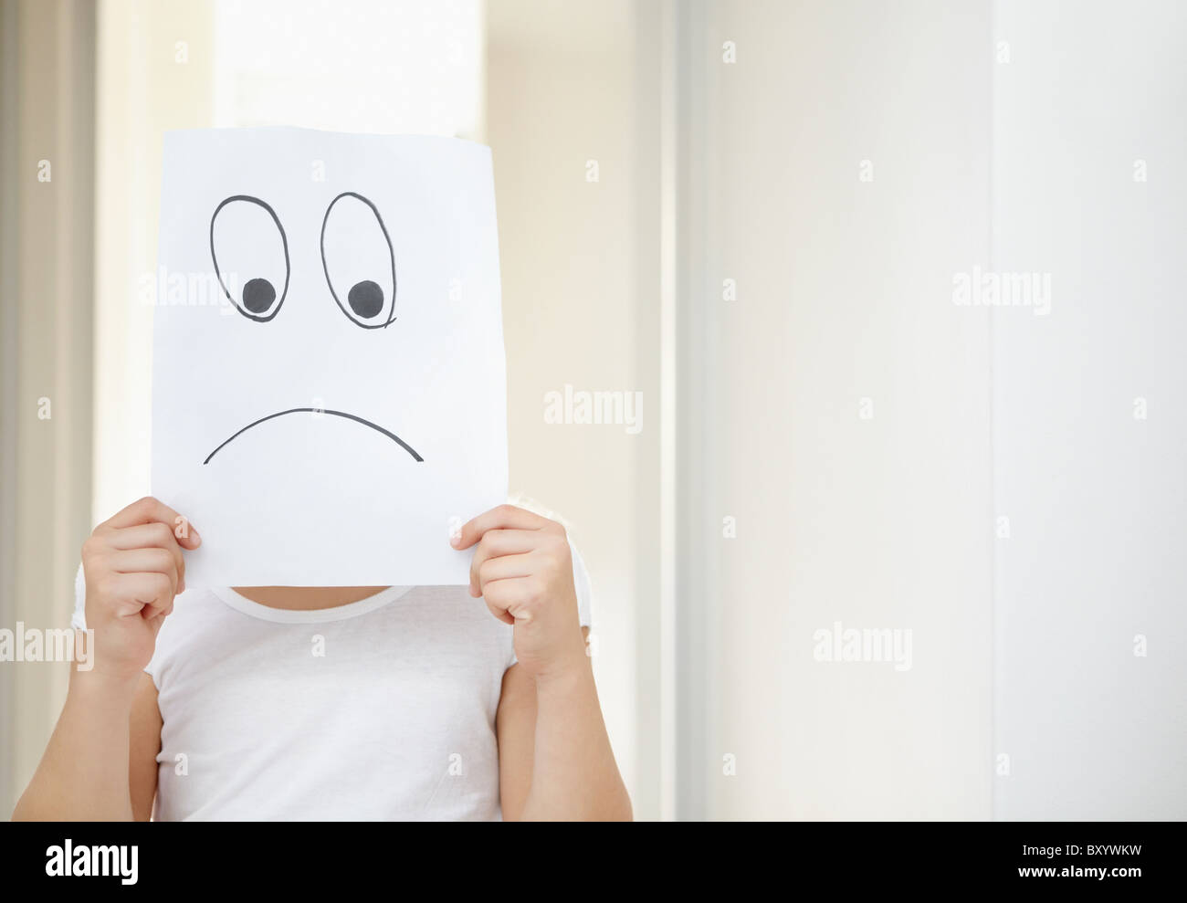 Girl girl holding sad face in front of herself Stock Photo - Alamy