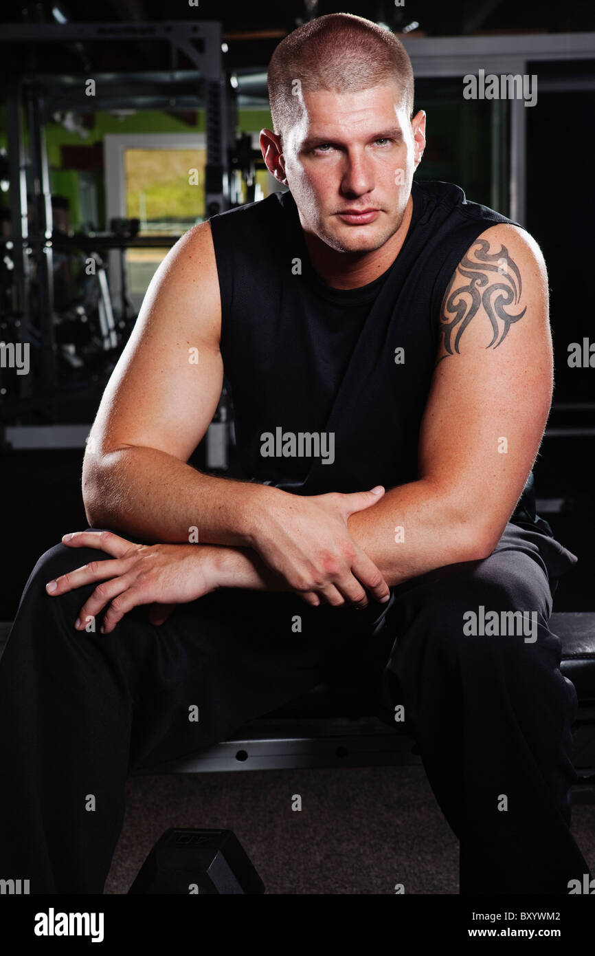Mad adult man sitting in gym Stock Photo - Alamy