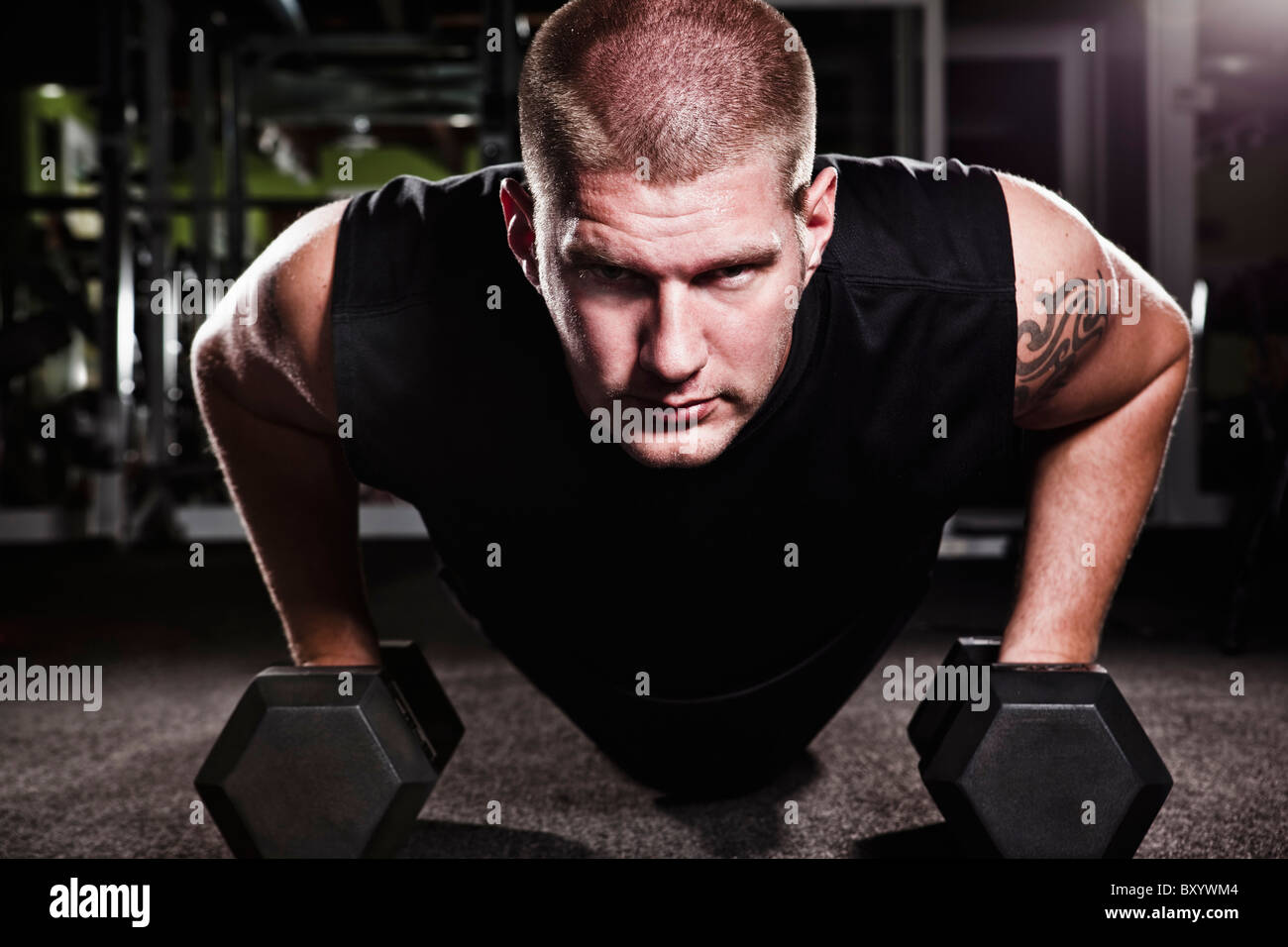 Mid adult man working out in gym Stock Photo - Alamy