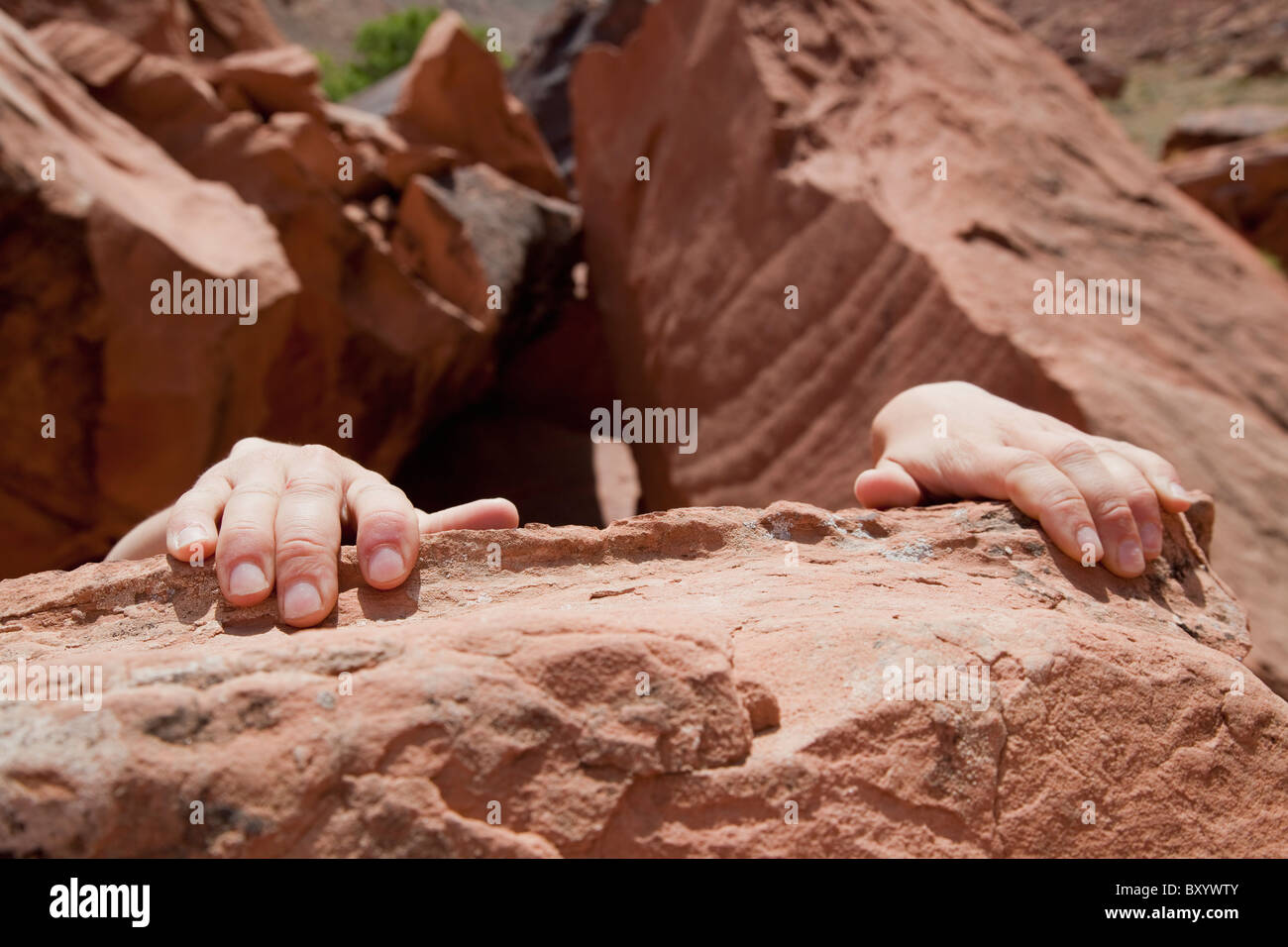 Young woman's hands on rocks Stock Photo - Alamy