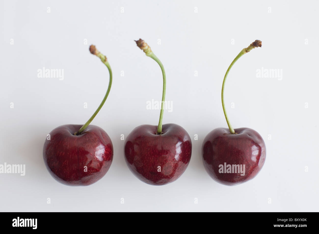 Three ripe cherries Stock Photo - Alamy