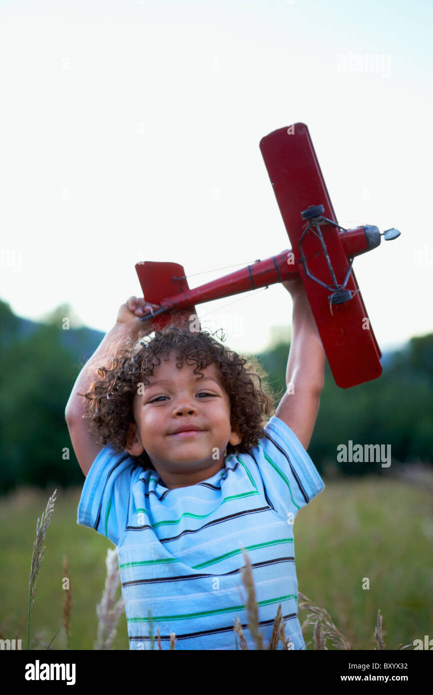 Portrait of boy playing with toy aeroplane Stock Photo - Alamy