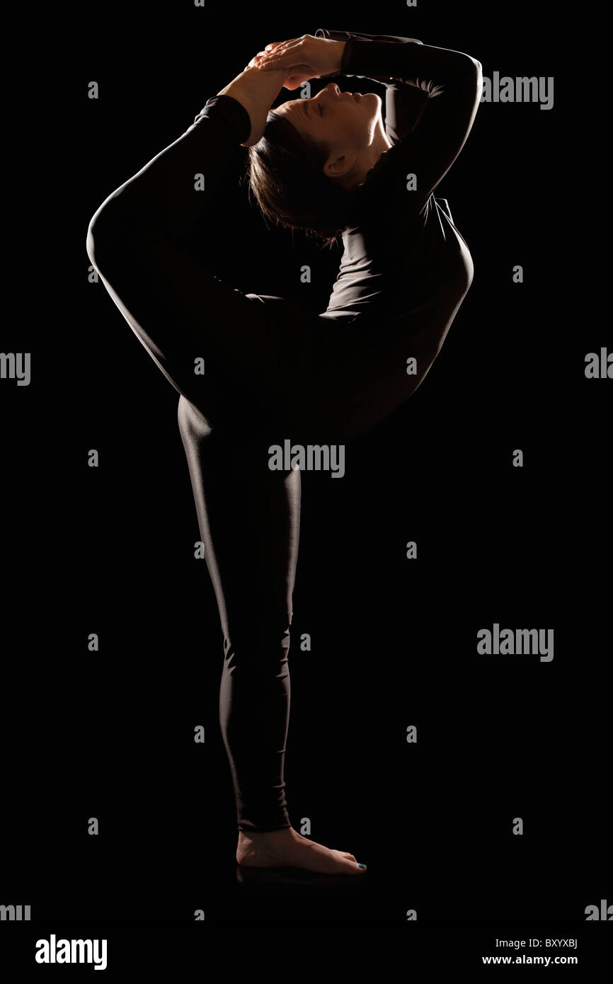 Female contortionist on black background Stock Photo - Alamy