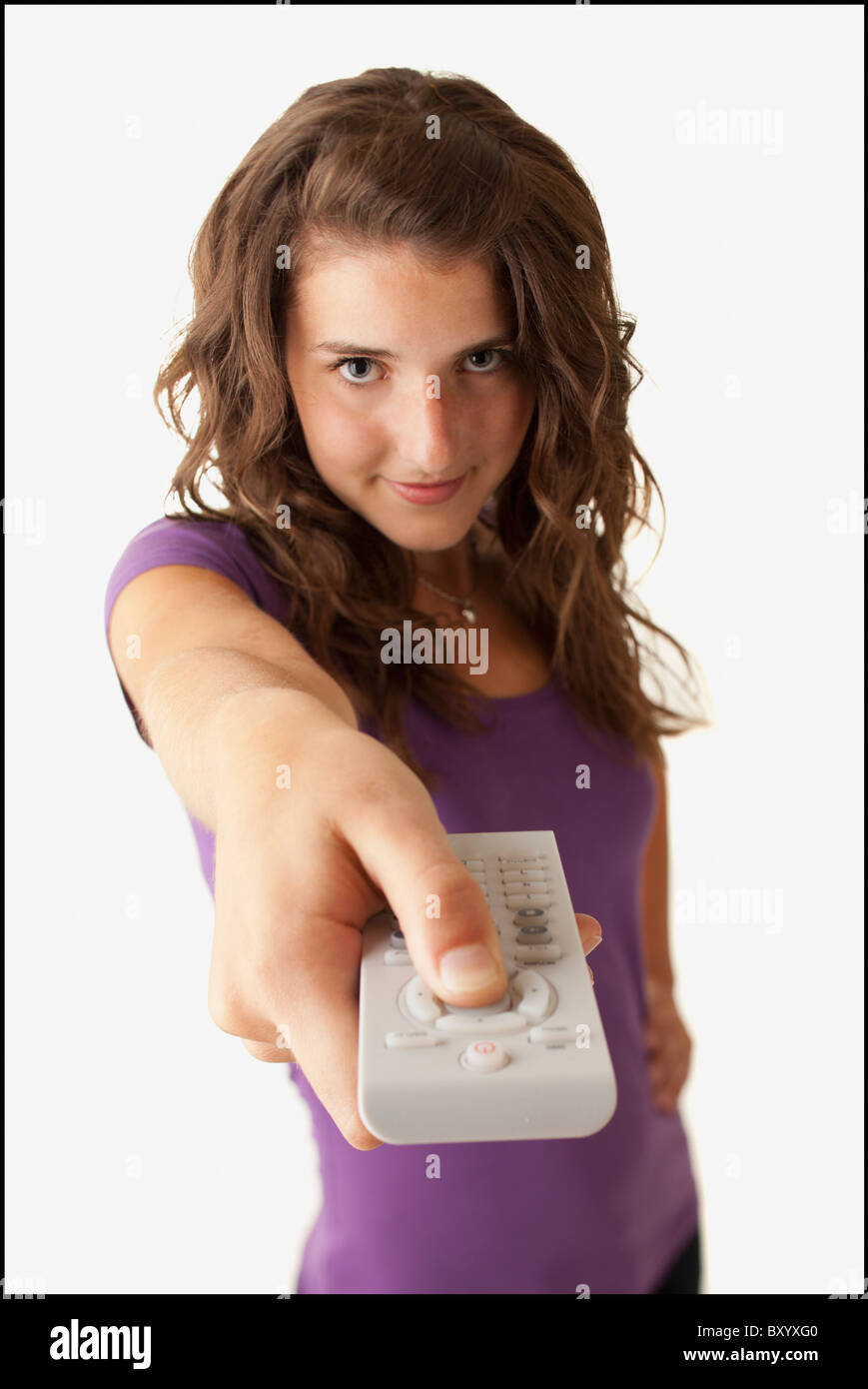 Young woman holding remote control Stock Photo - Alamy