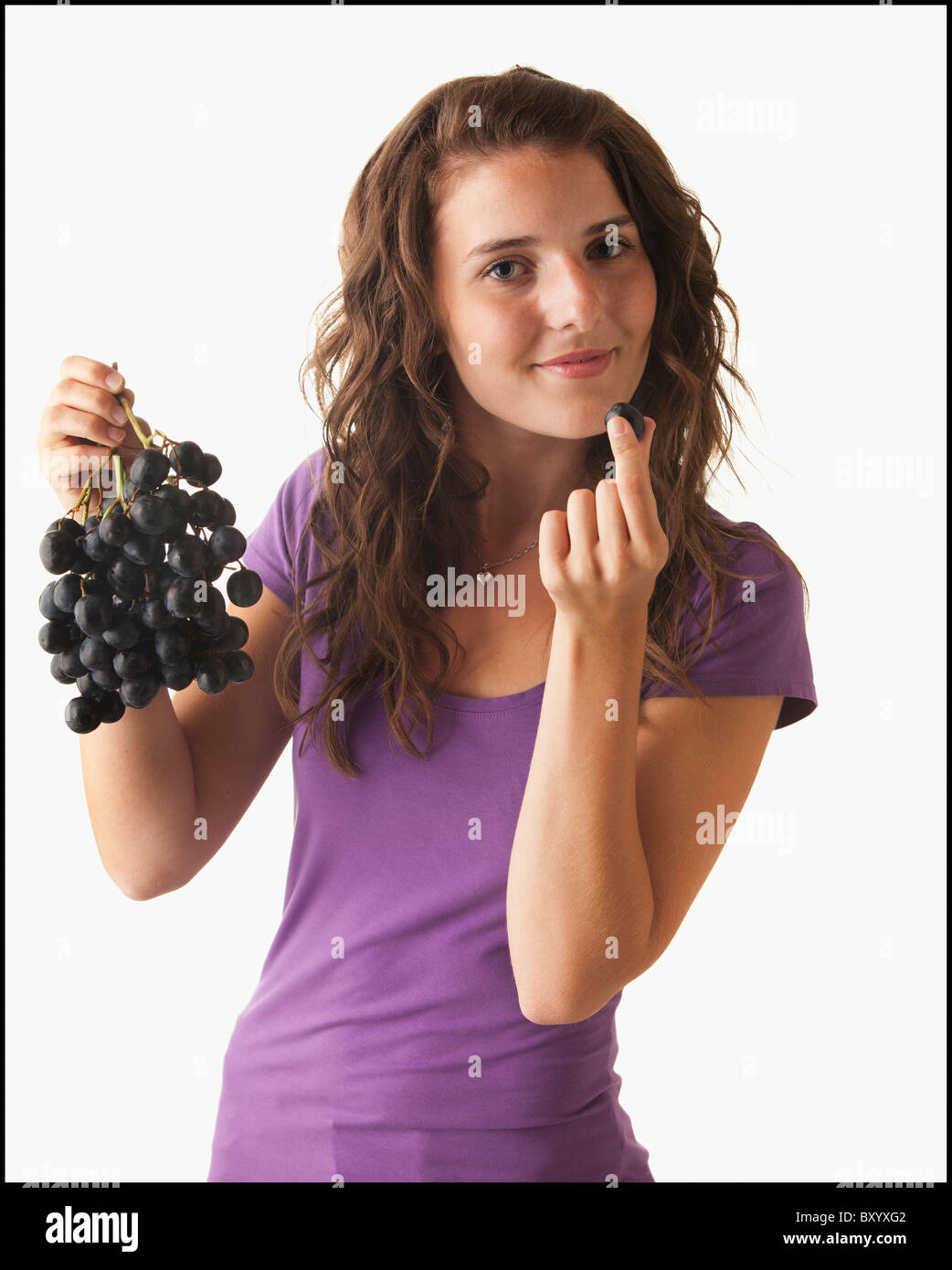 Young woman eating grapes Stock Photo - Alamy