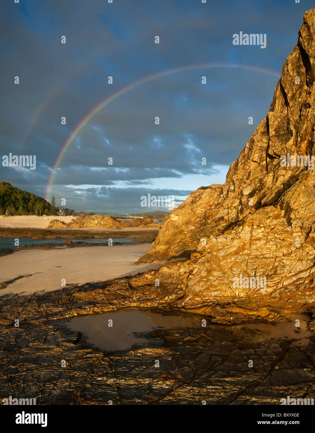 cliff face with rainbow in background Stock Photo - Alamy