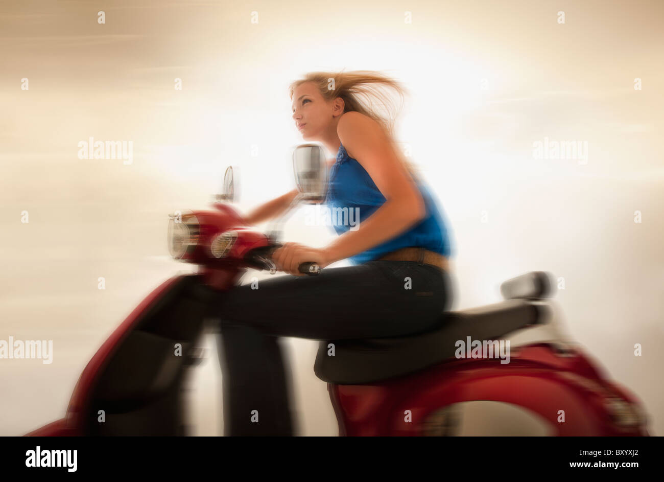 Young girl riding scooter Stock Photo - Alamy
