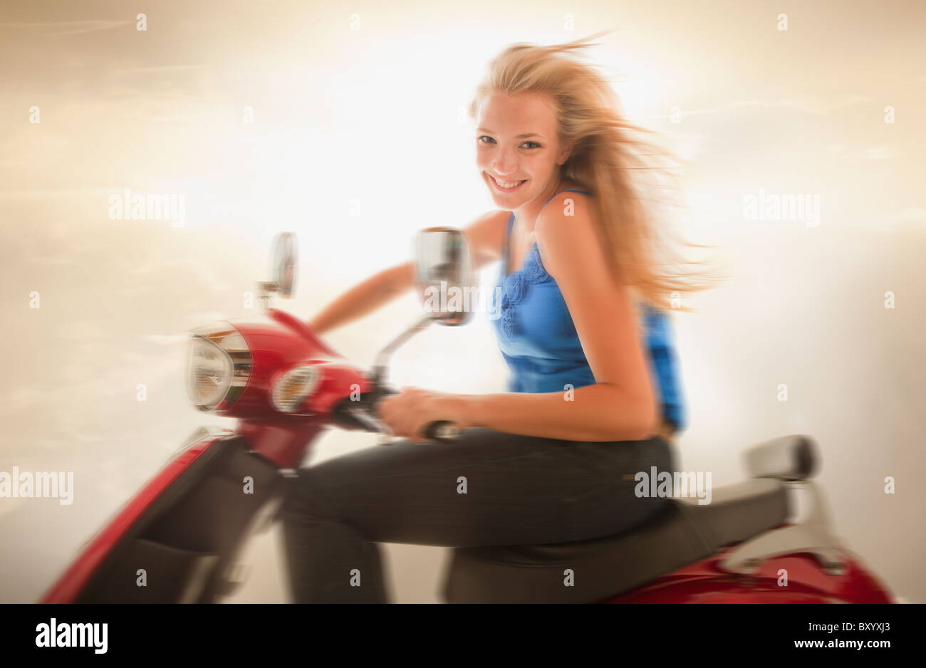 Young girl riding scooter Stock Photo - Alamy