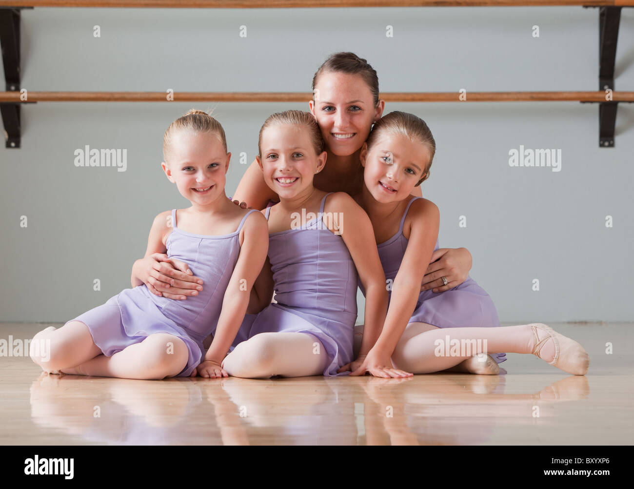 Portrait of female instructor with ballet dancers in dance studio Stock ...