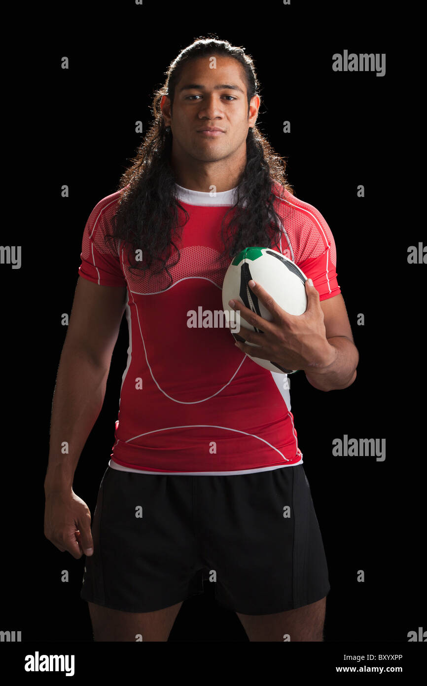 Studio portrait of male rugby player holding ball Stock Photo - Alamy