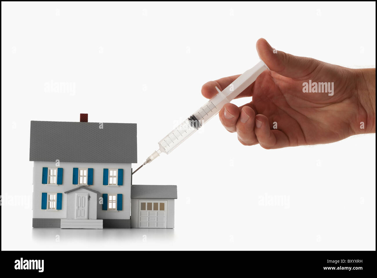 Girls hand injecting house Stock Photo - Alamy