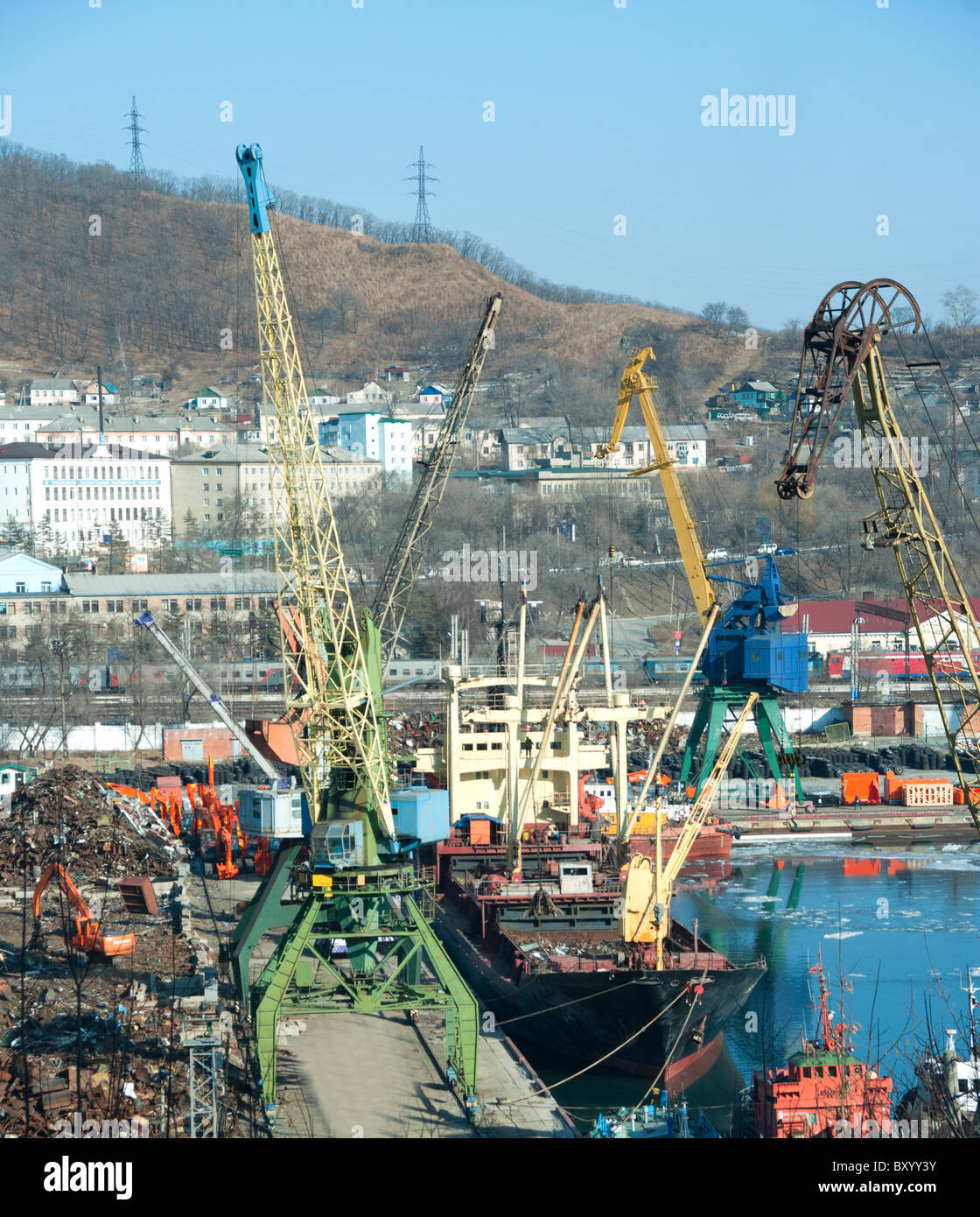 Scrap metal handling in an industrial port Stock Photo - Alamy