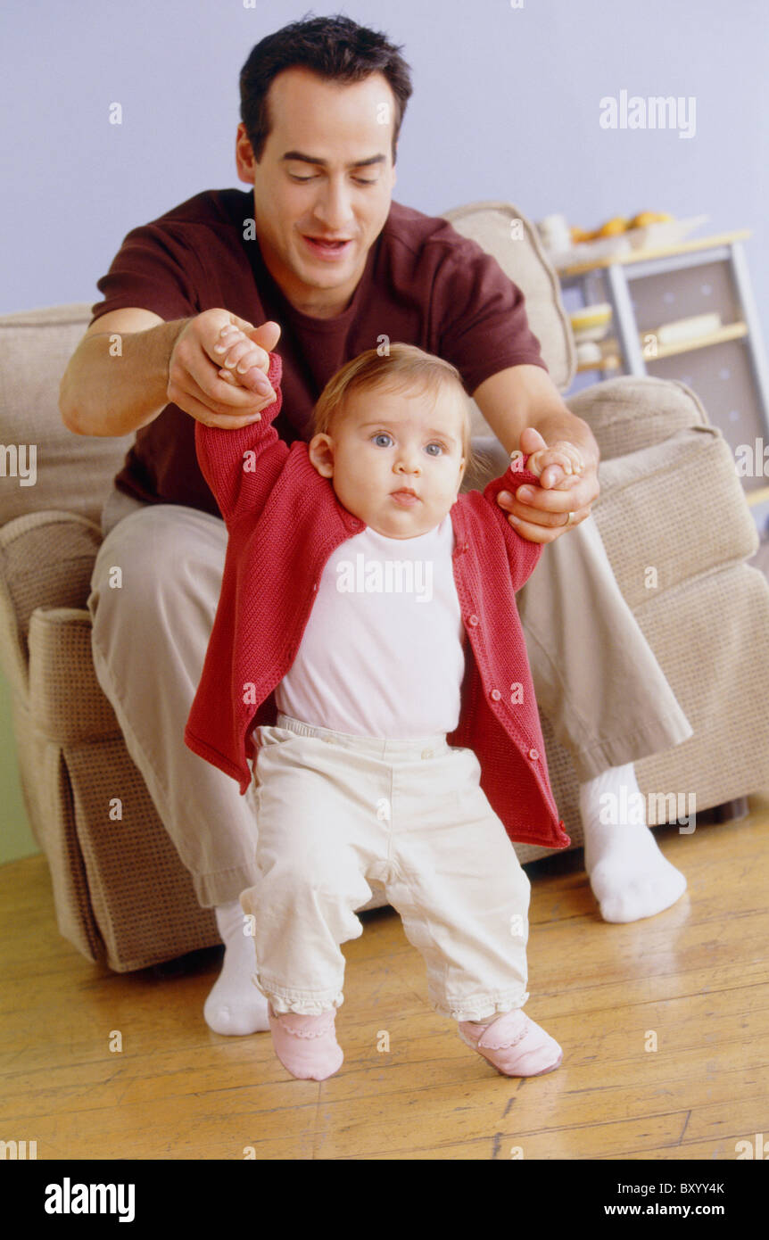 Baby trying to walk Stock Photo - Alamy