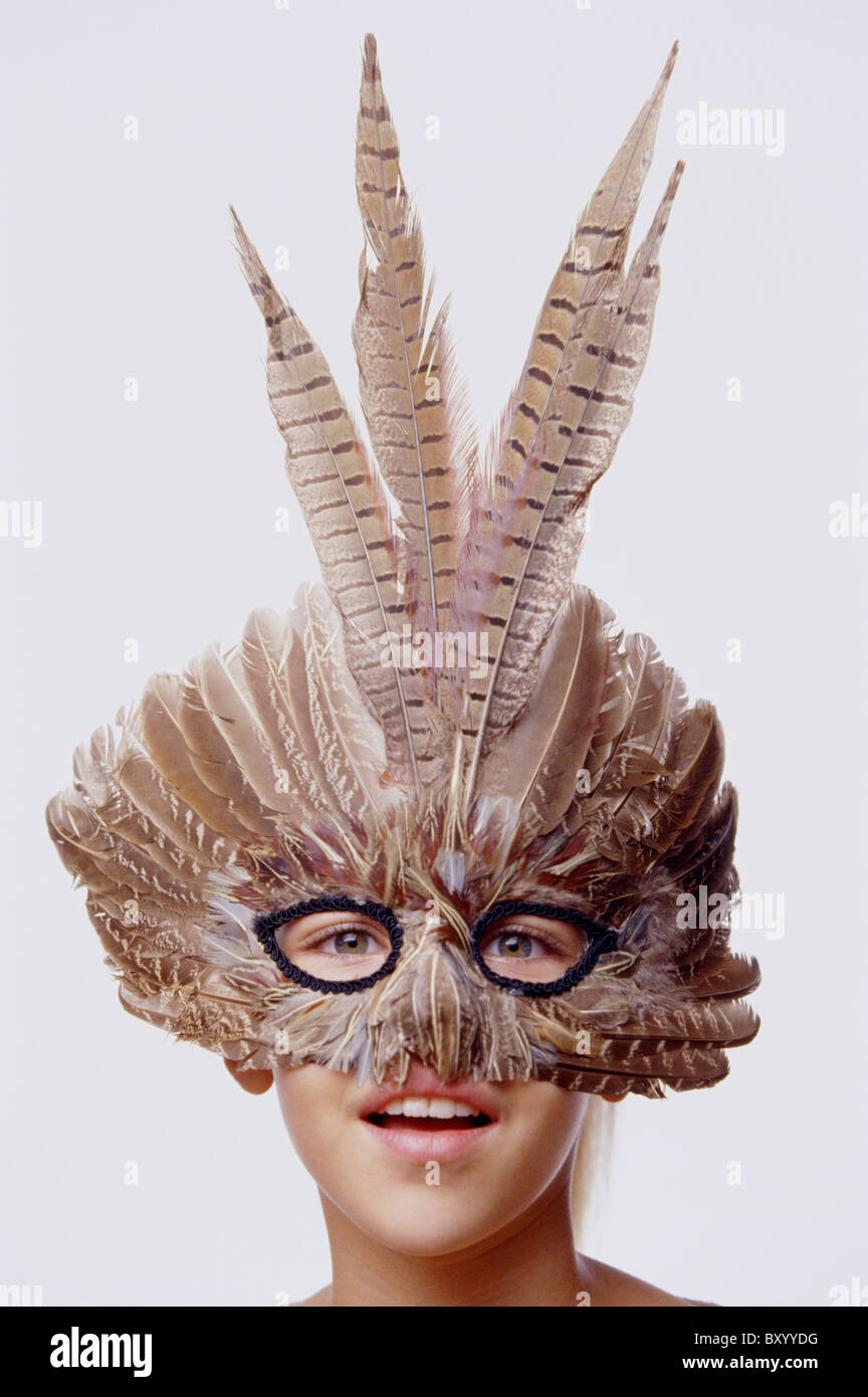Child wearing a feather mask Stock Photo - Alamy