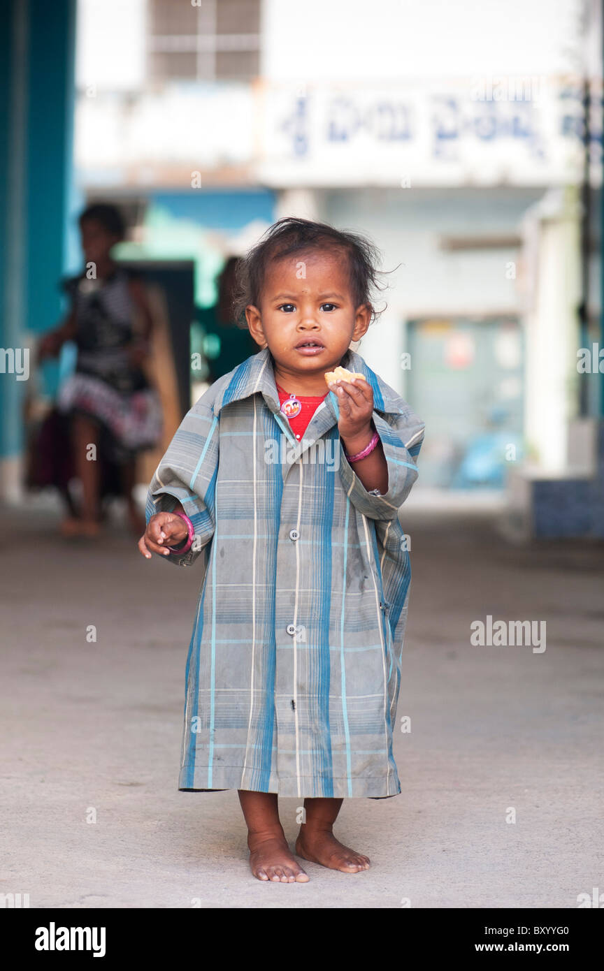 Baby indian boy eating a biscuit. Andhra Pradesh, India. Selective ...