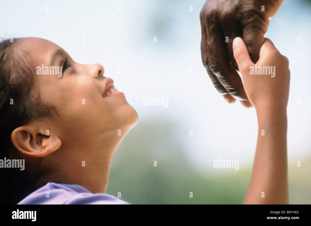Young girl holding adult's hand Stock Photo - Alamy