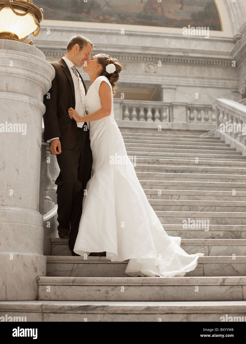 Bride and groom kissing on steps Stock Photo - Alamy