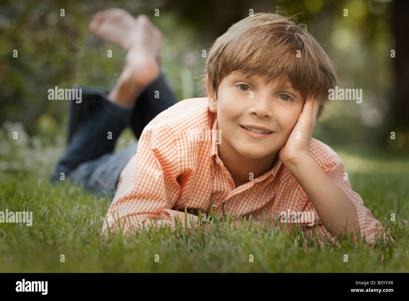 Portrait of boy lying on grass Stock Photo - Alamy