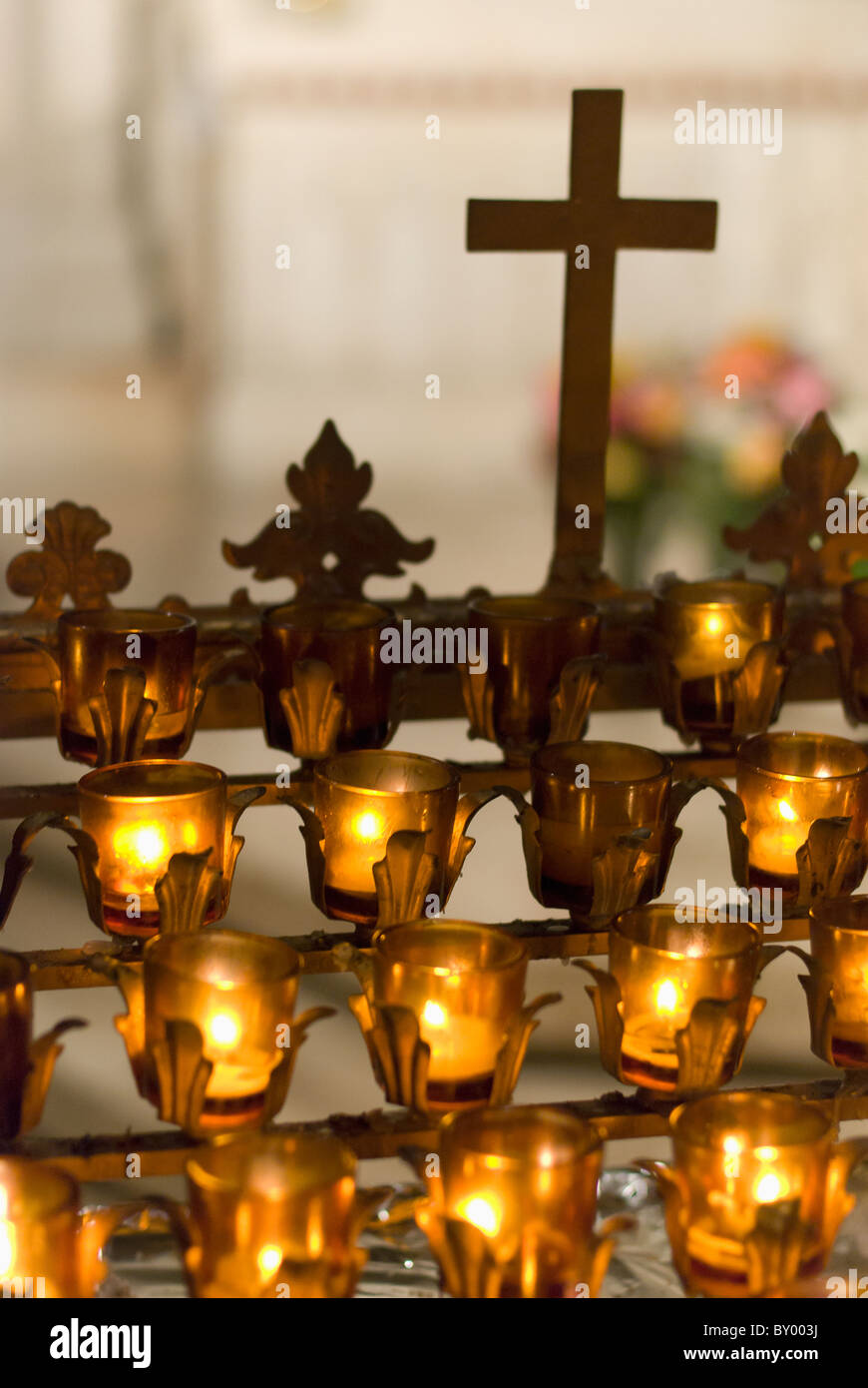 Cross with candles in cathedral Stock Photo - Alamy