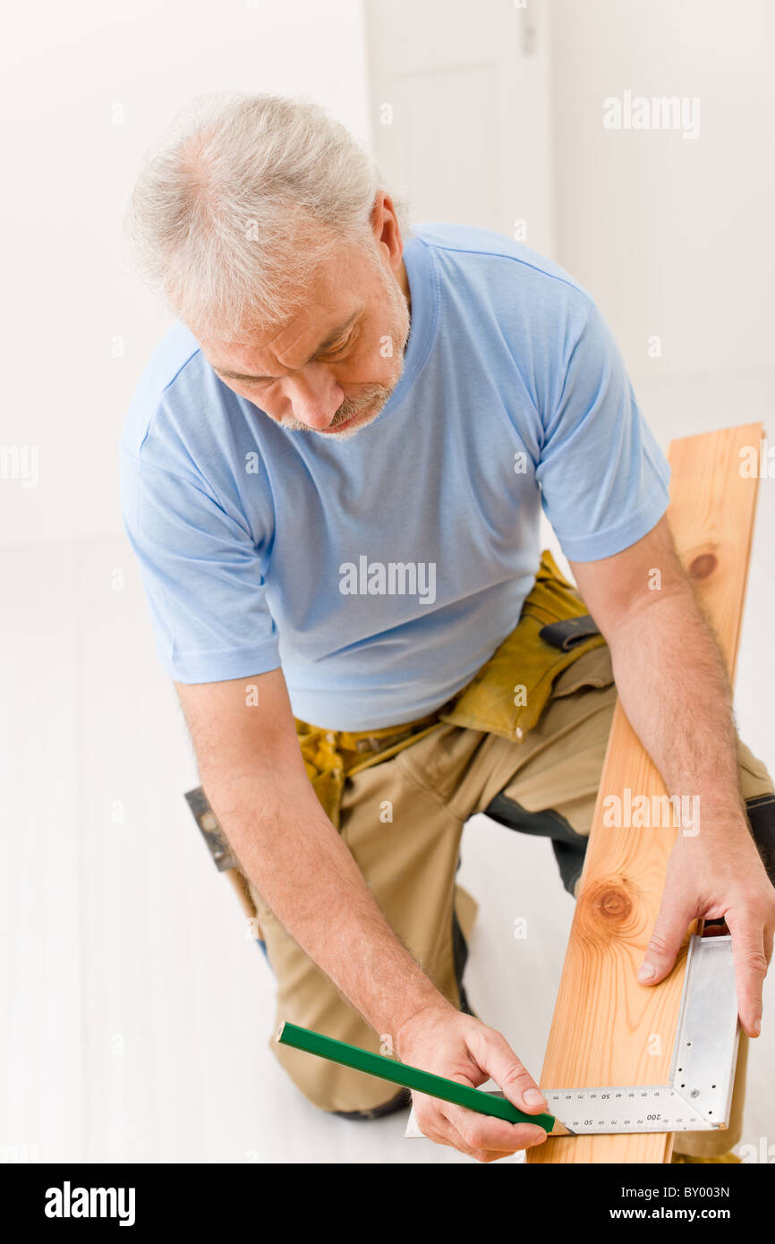 Home improvement - handyman installing wooden floor home Stock Photo ...