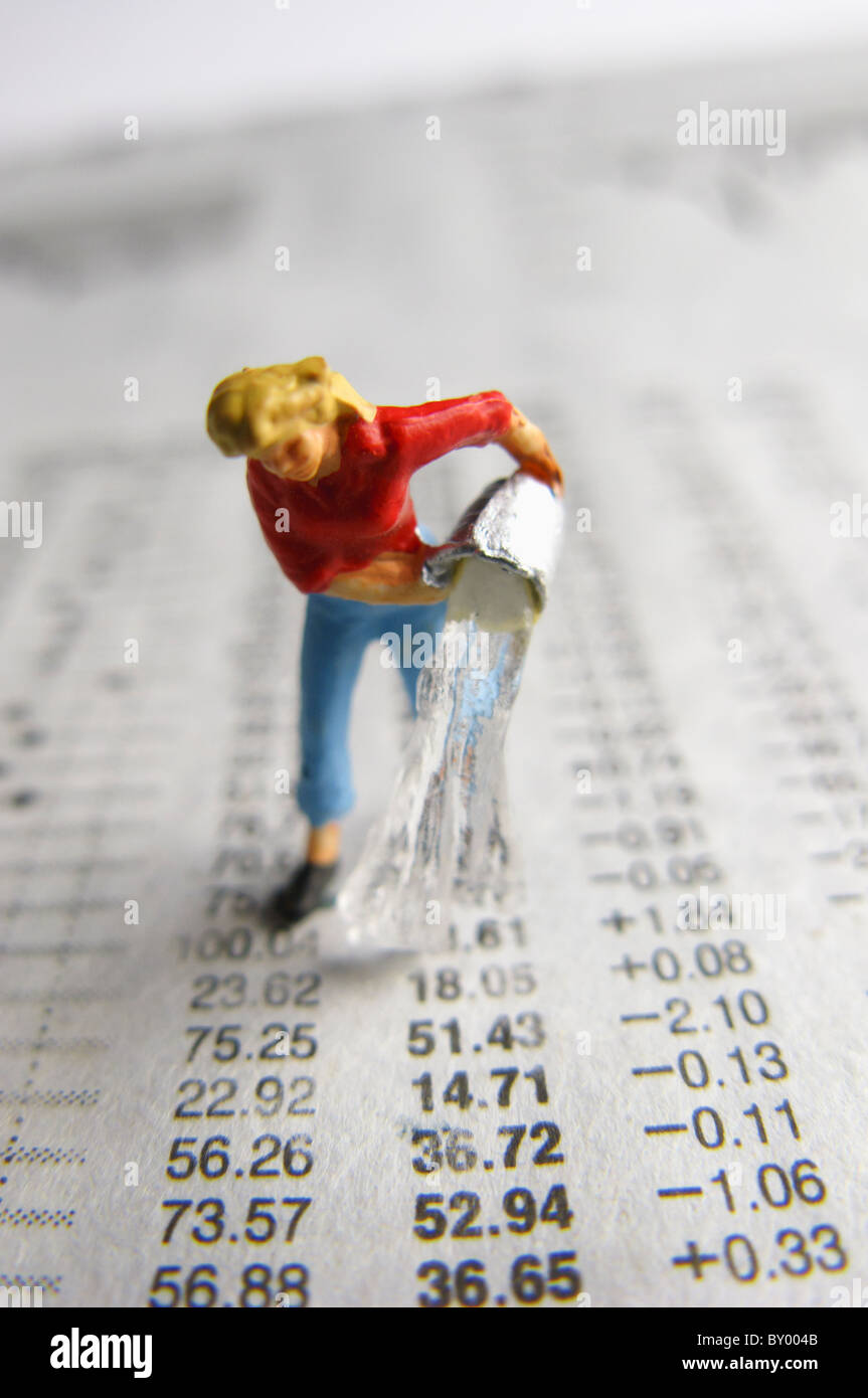 Model woman pouring water on financial figures Stock Photo - Alamy
