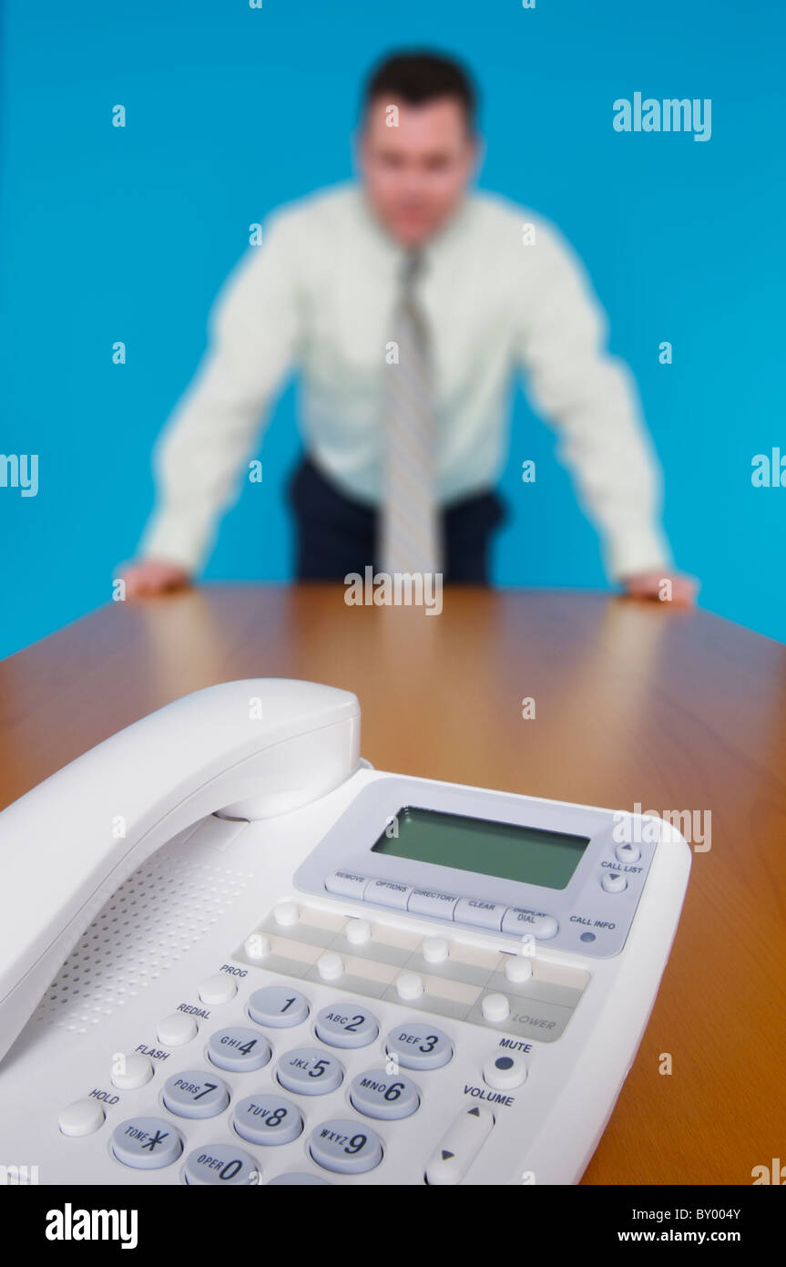 Businessman waiting by telephone Stock Photo - Alamy