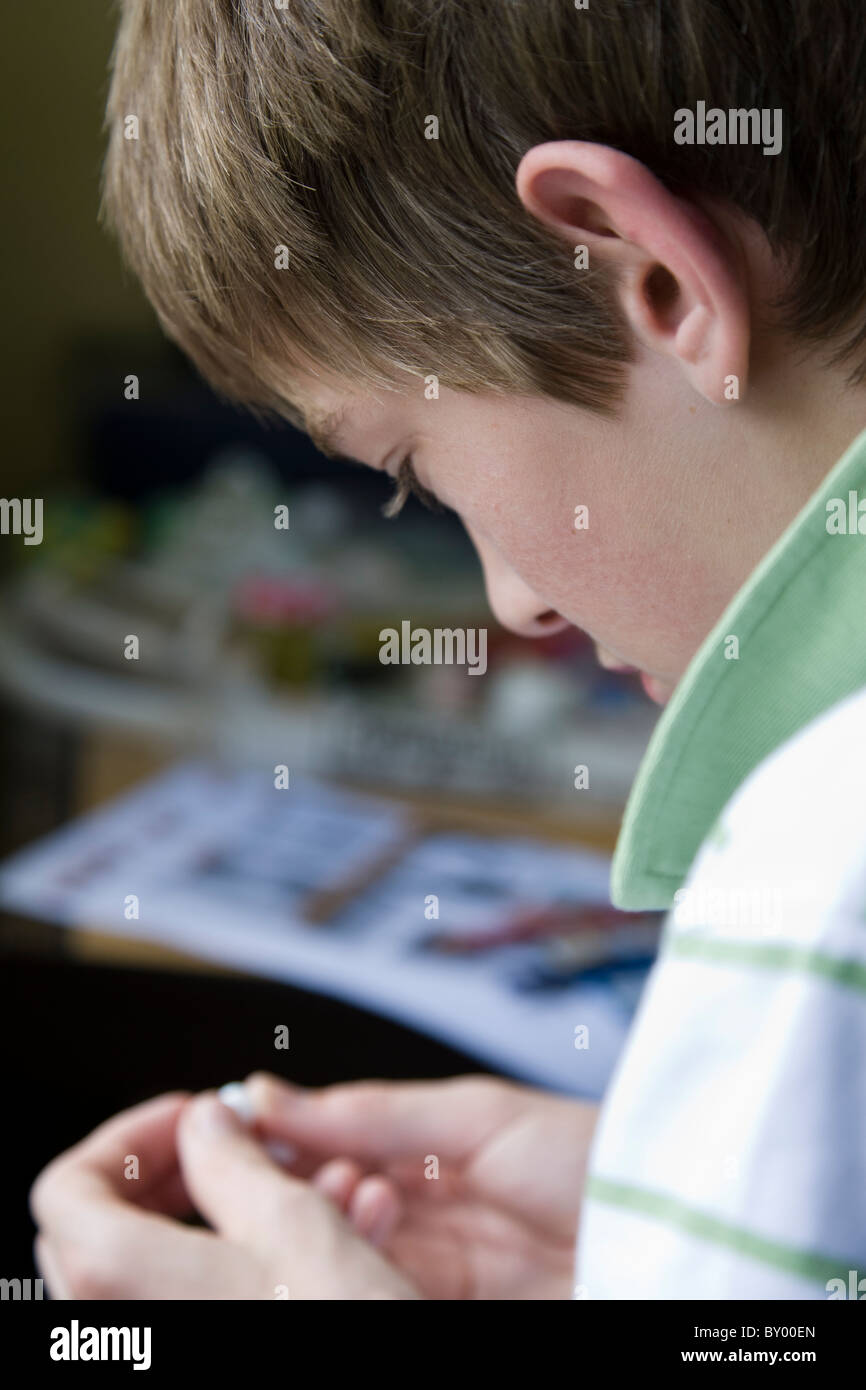 Teenage boy concentrating Stock Photo - Alamy