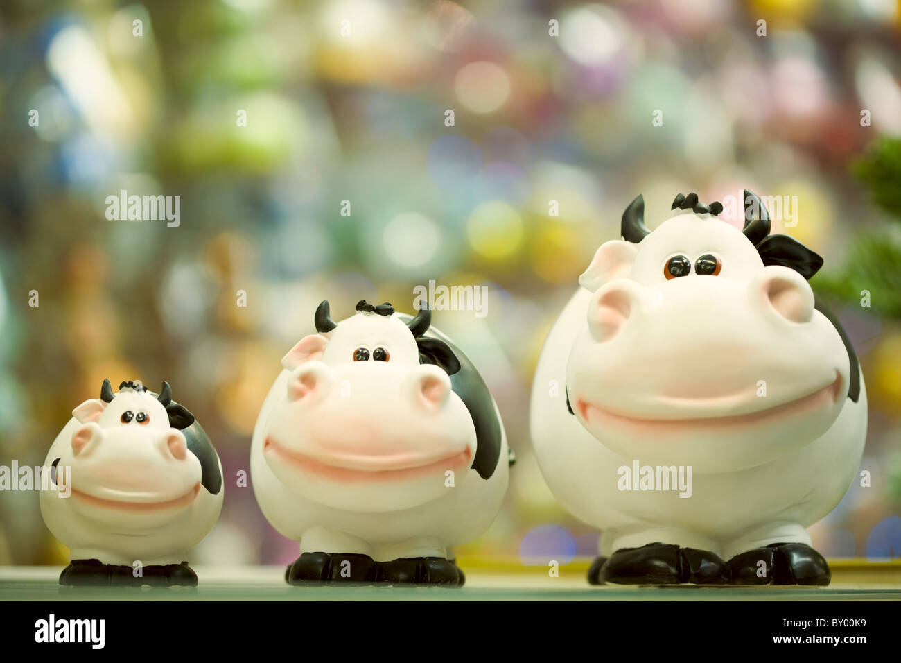 Image of three fat toy cows standing in line on shop window Stock Photo ...