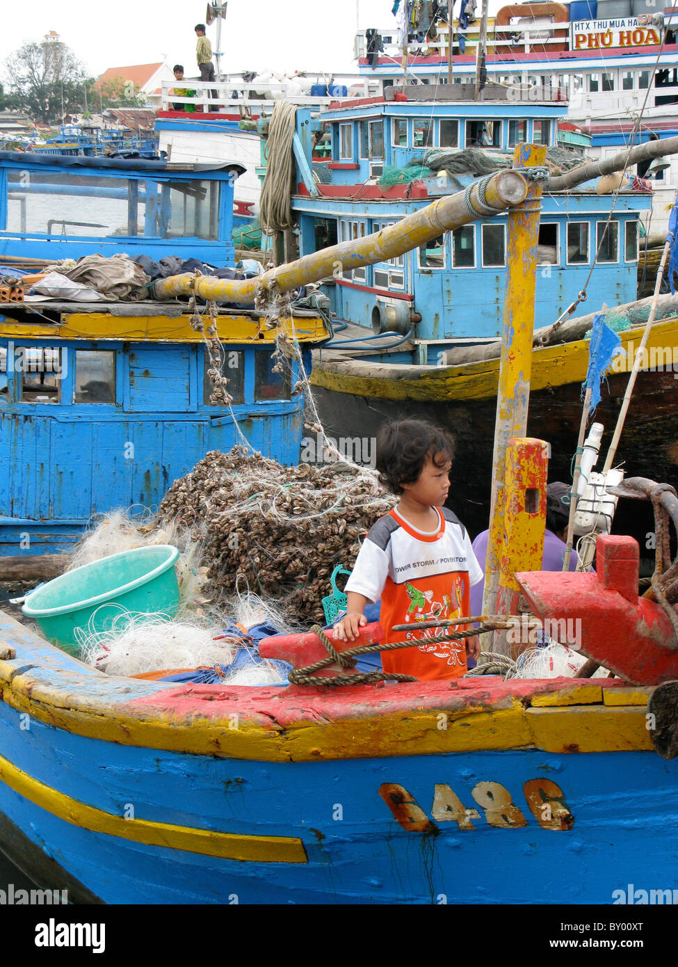 Boy on a fishing boat in Vietnam Stock Photo - Alamy