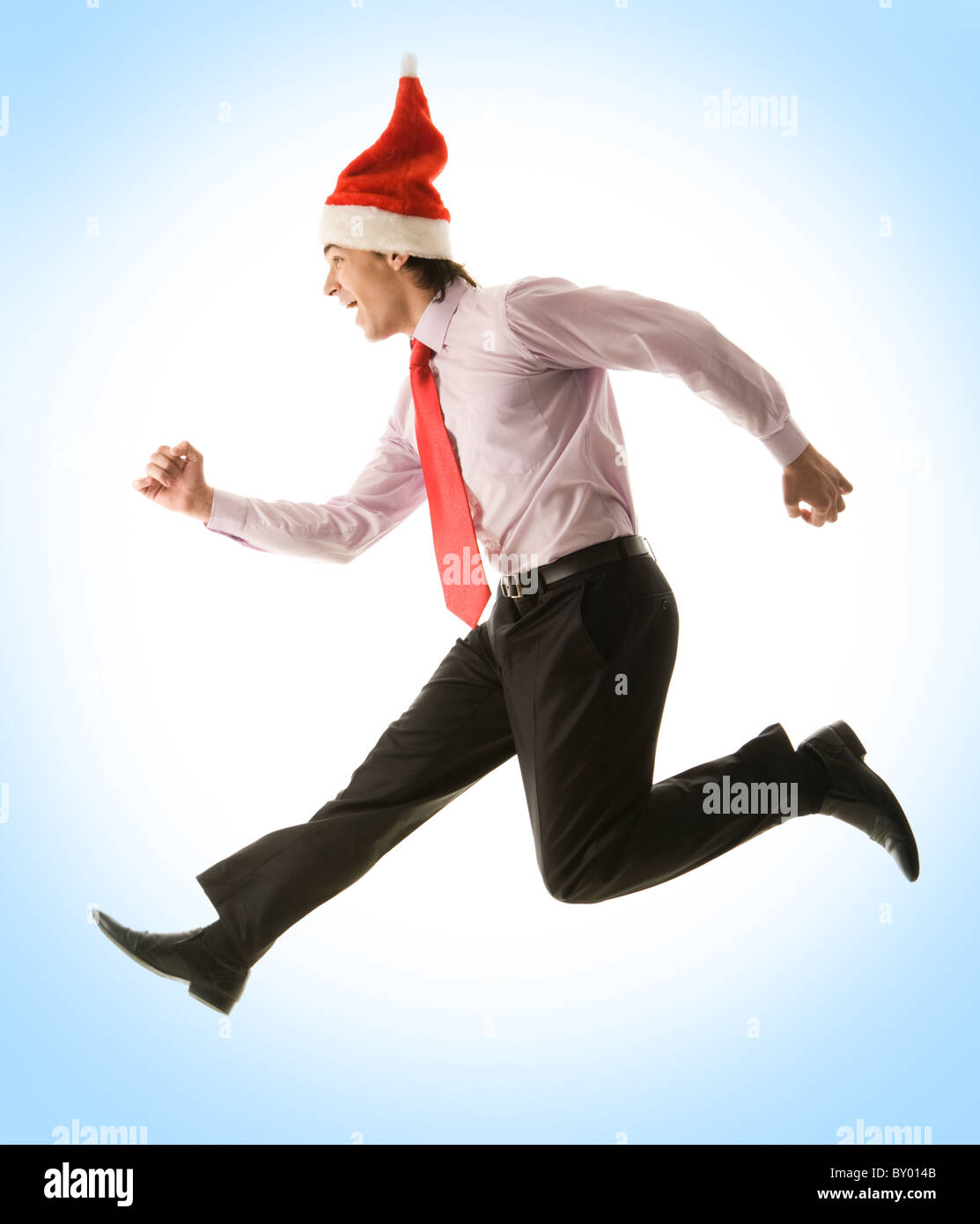 Profile of joyful business Santa jumping high over blue background ...