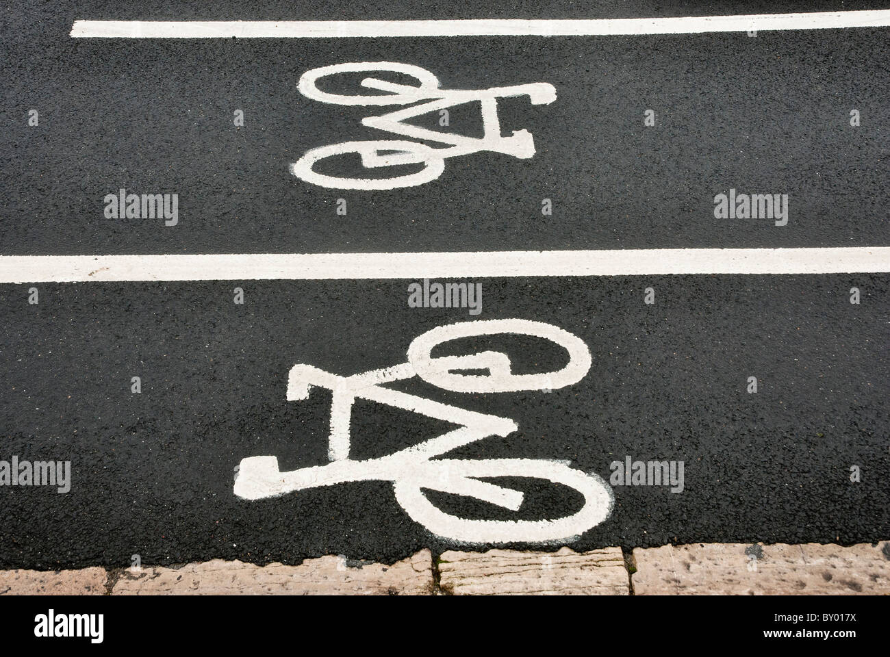 Cycle lanes symbols painted on road Stock Photo - Alamy