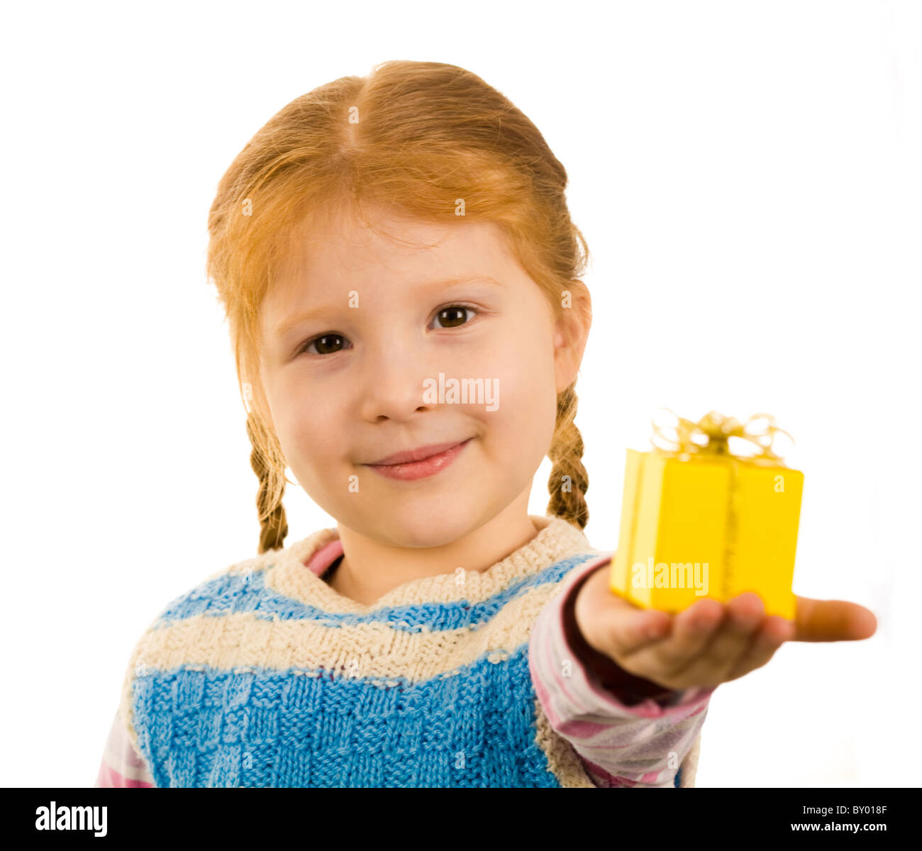 Pretty child holding small giftbox on her palm while stretching it to ...