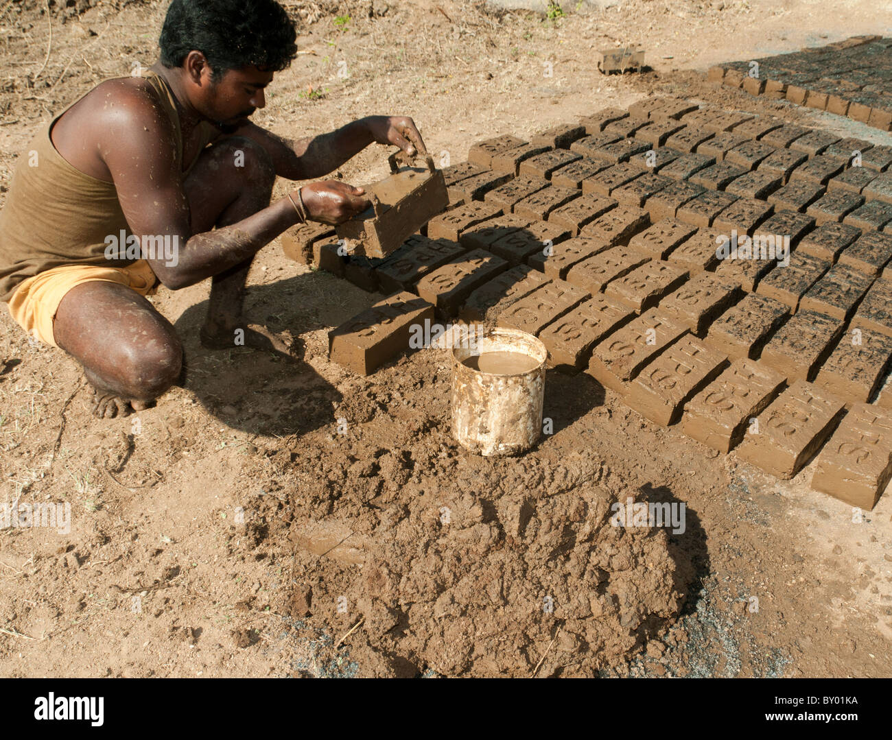 A man making bricks by hand that are then dried in the sun In India ...