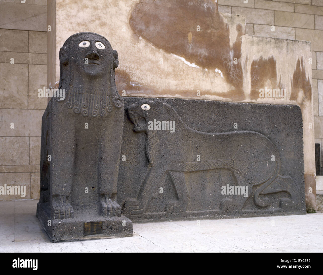 Sphinx and a lion in relief. Basalt. Guarding the temple of Tell Halaf ...